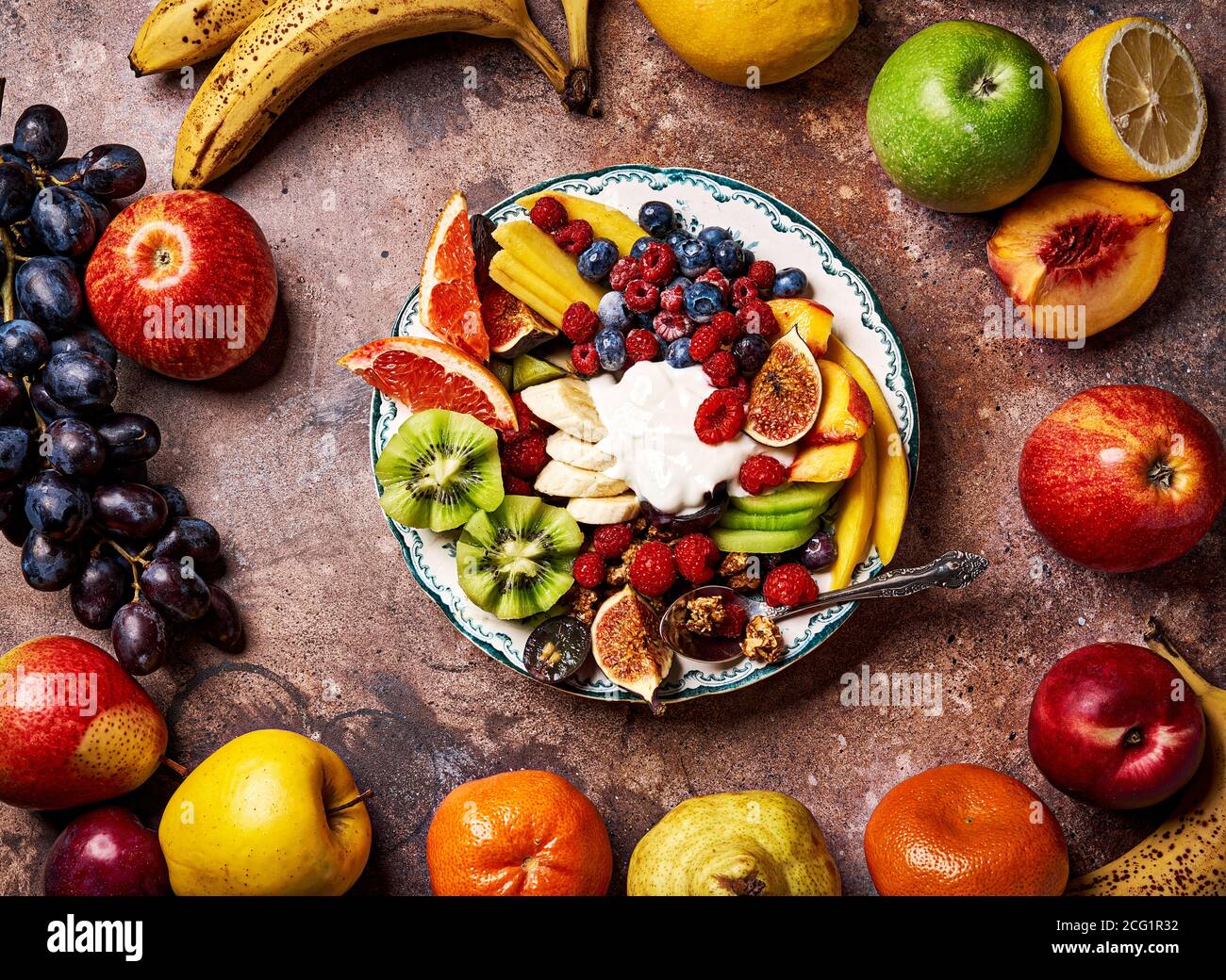 Assorted sliced fruits on vintage plate. Mango, kiwi fruits, figs ...