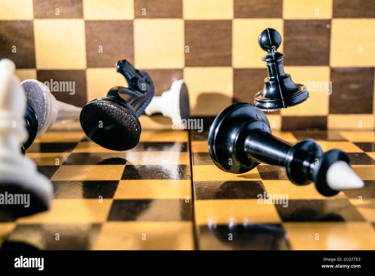 concept, chess pieces falling on the chessboard Stock Photo - Alamy