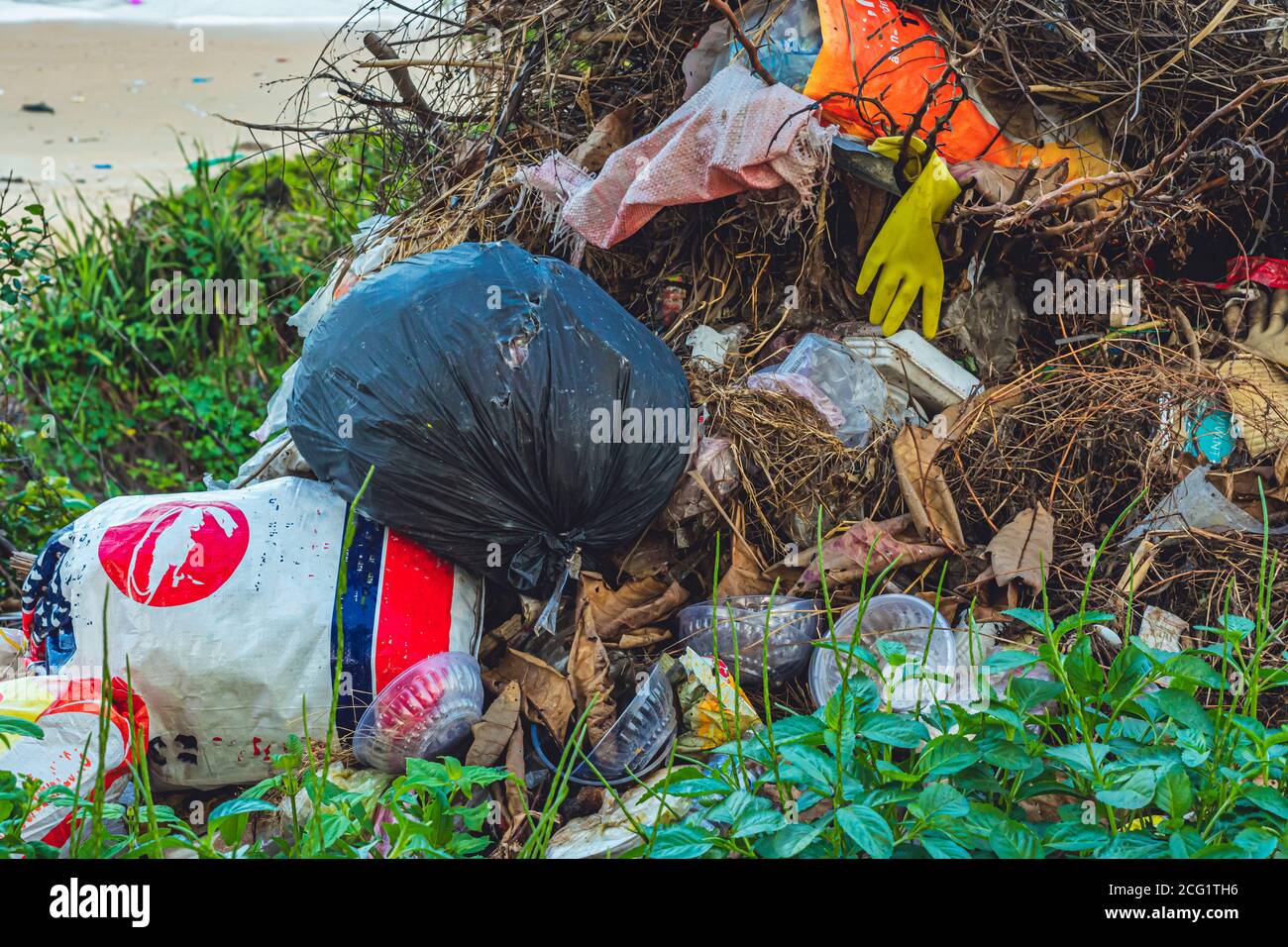 Spilled recycling man made garbage in park forest near city. Empty used ...