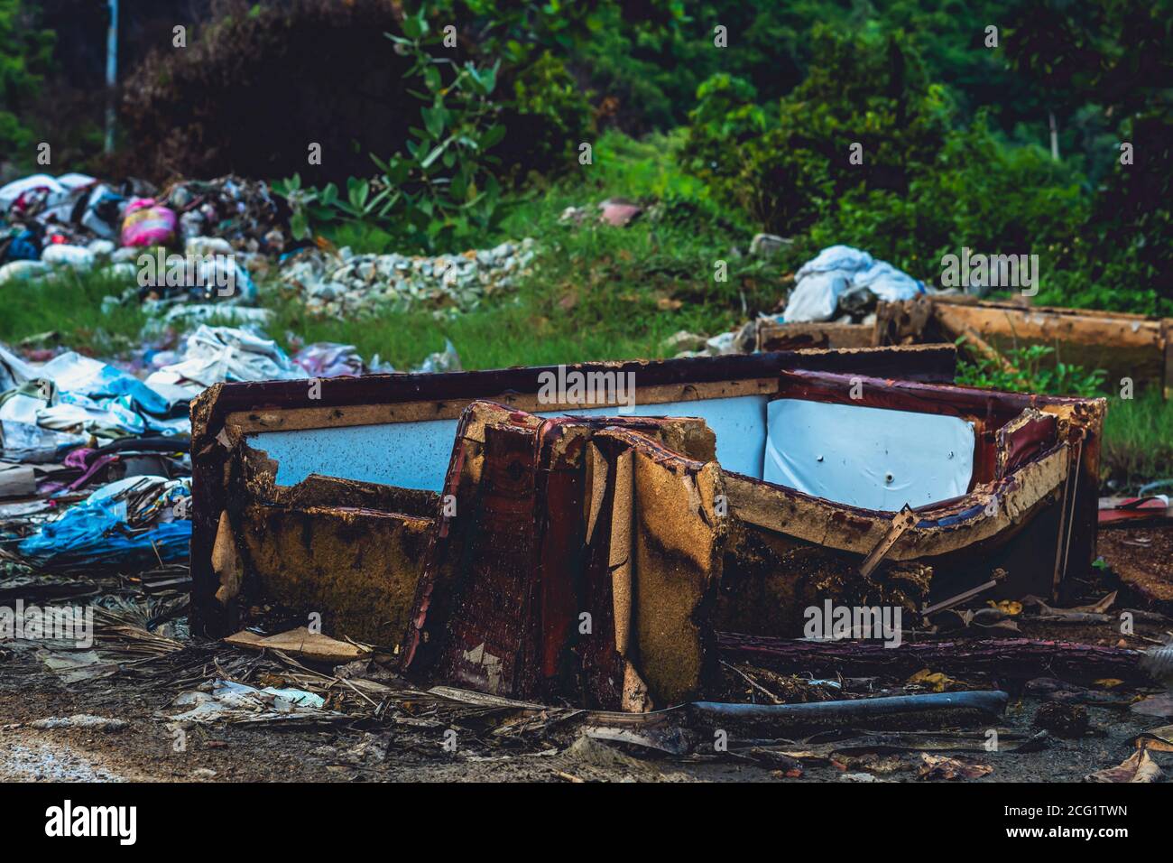 Spilled recycling man made garbage in park forest outside city. Used ...