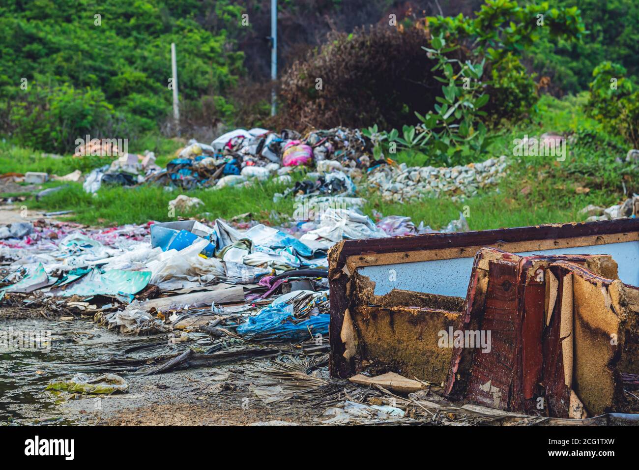 Spilled recycling man made garbage in park forest outside city. Used ...