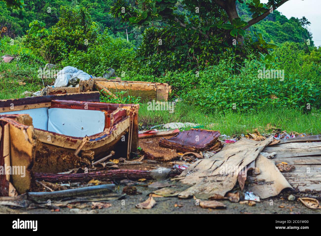 Spilled recycling man made garbage in park forest outside city. Used ...