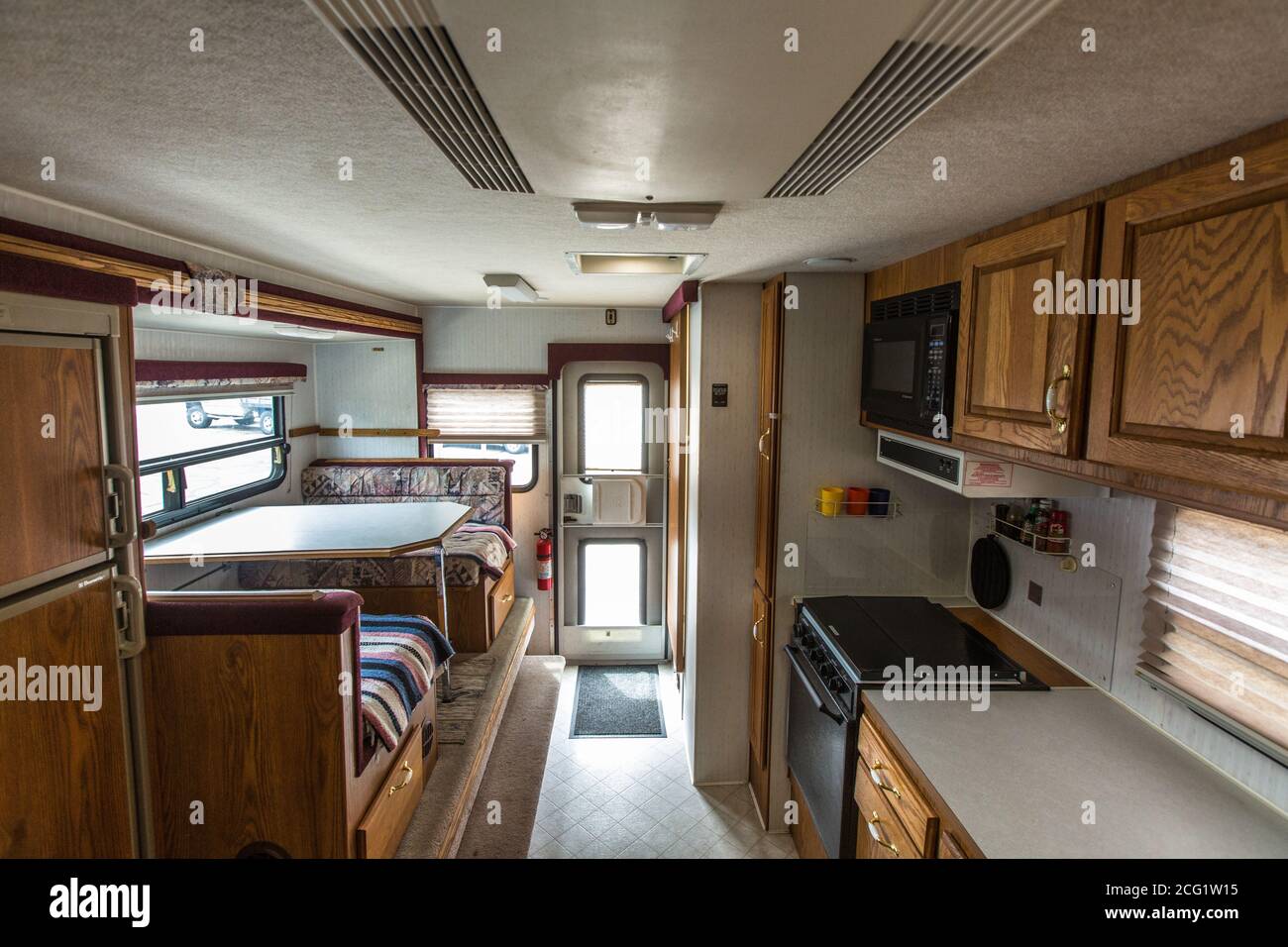 Interior of an Artic Fox truck camper showing the kitchen and dinette ...