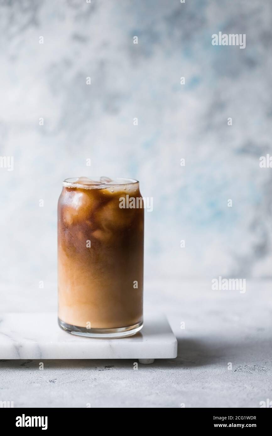 Frappe milk shake coffee in tall glass on blue background Stock Photo ...