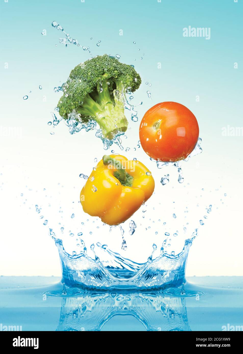 Vegetables falling with splashing water Stock Photo - Alamy