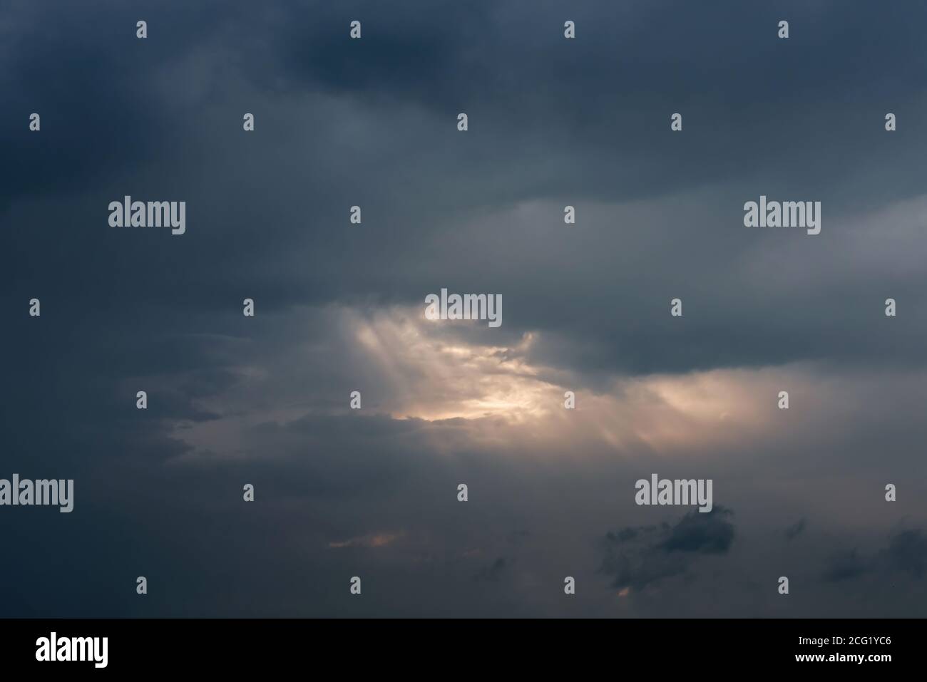 Rays of light shining through dark clouds, dramatic sky with cloud. Ray ...