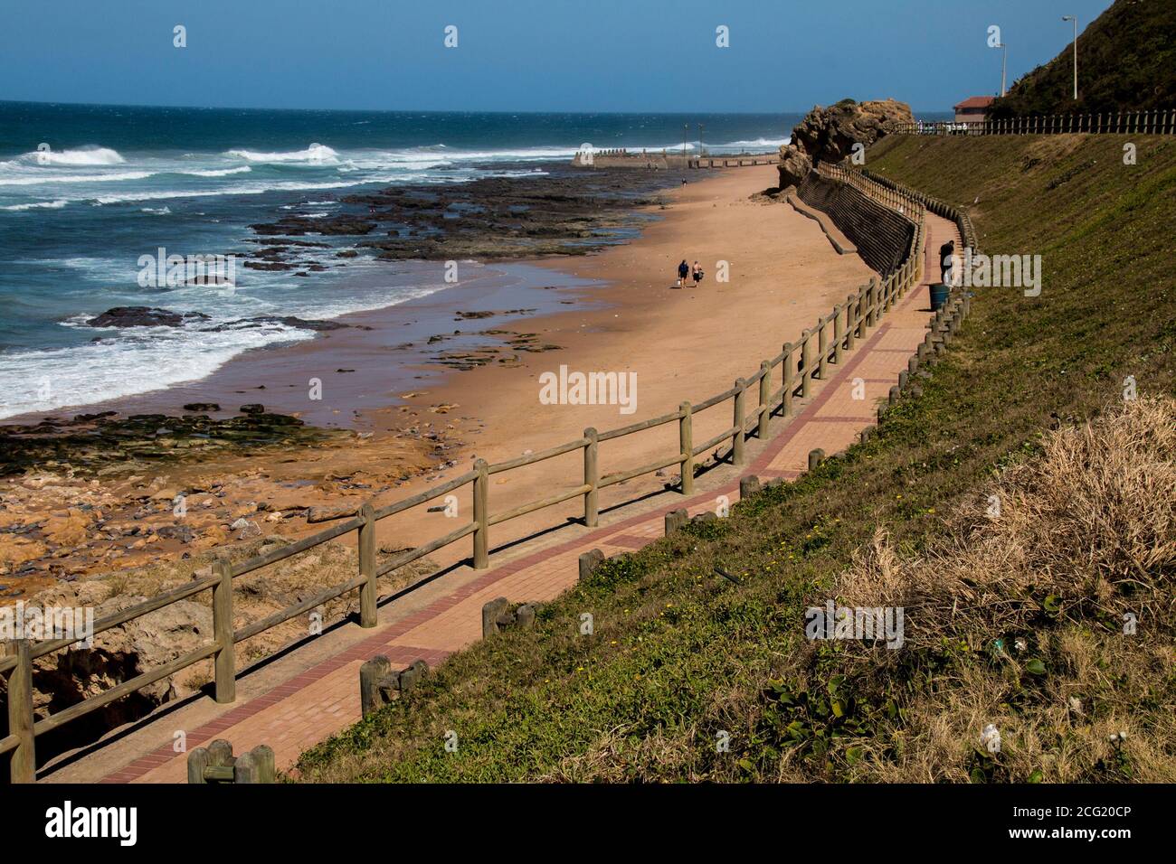 Wood fence between walkway and beach with tidal pool Stock Photo - Alamy