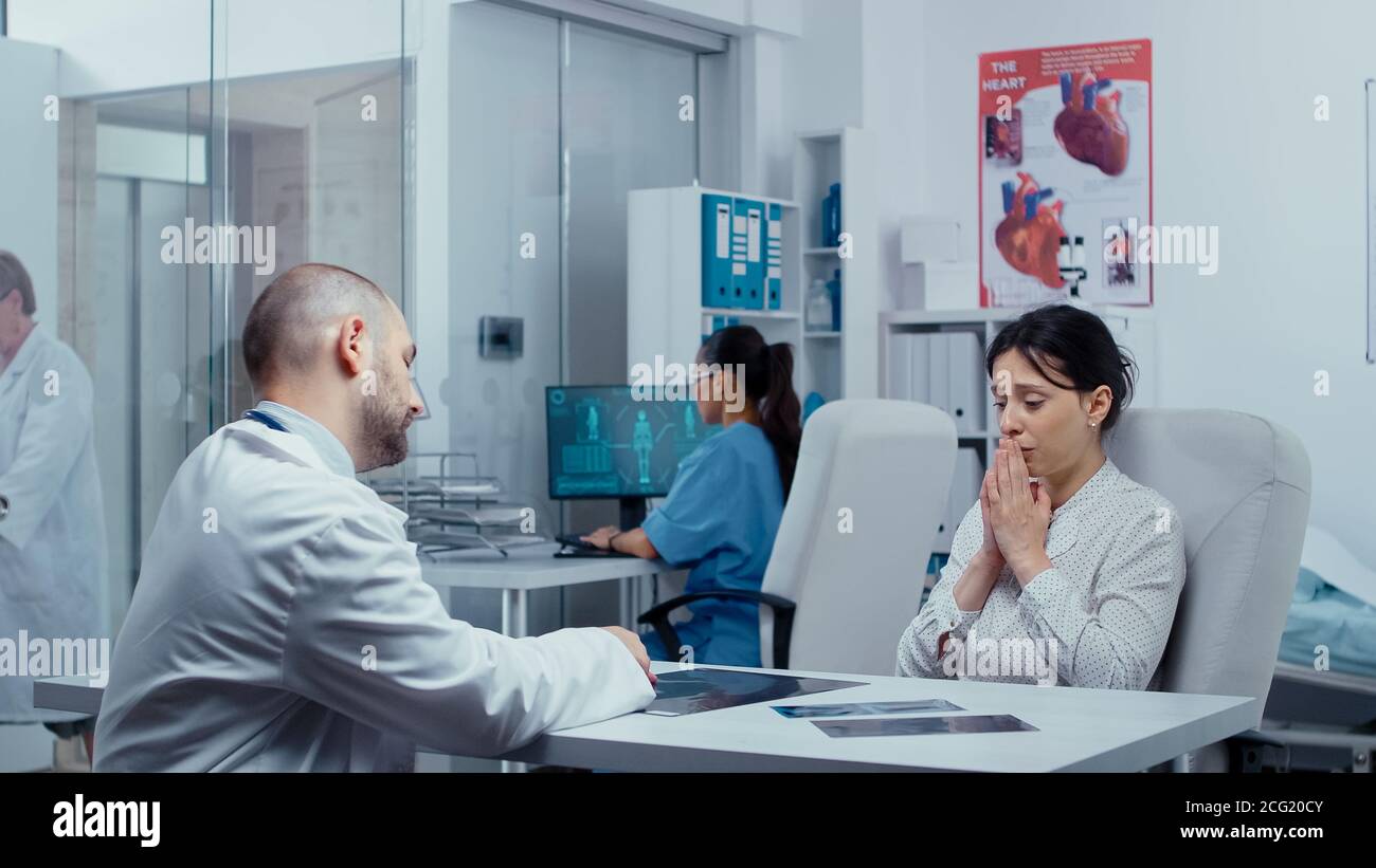 Young woman receiving devastating news from doctor about her health ...