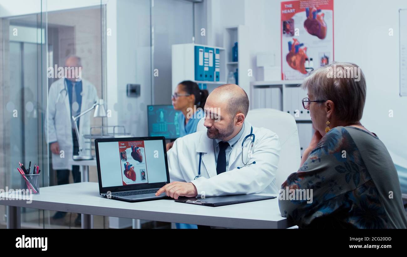 Doctor with patient heart attach hi-res stock photography and images ...