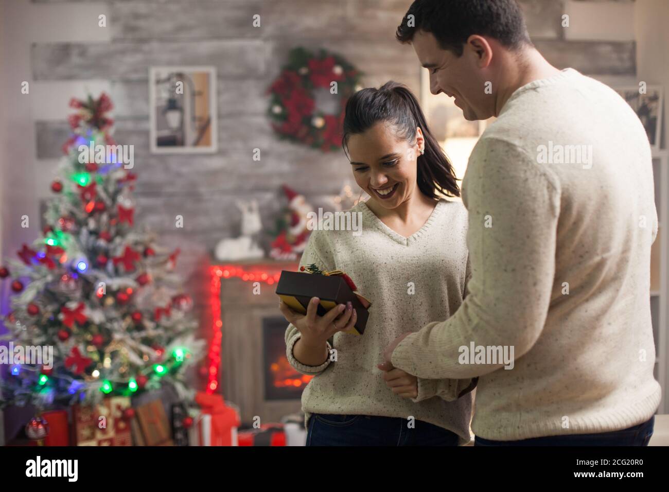 Happy girlfriend about her christmas gift from boyfriend and christmas ...