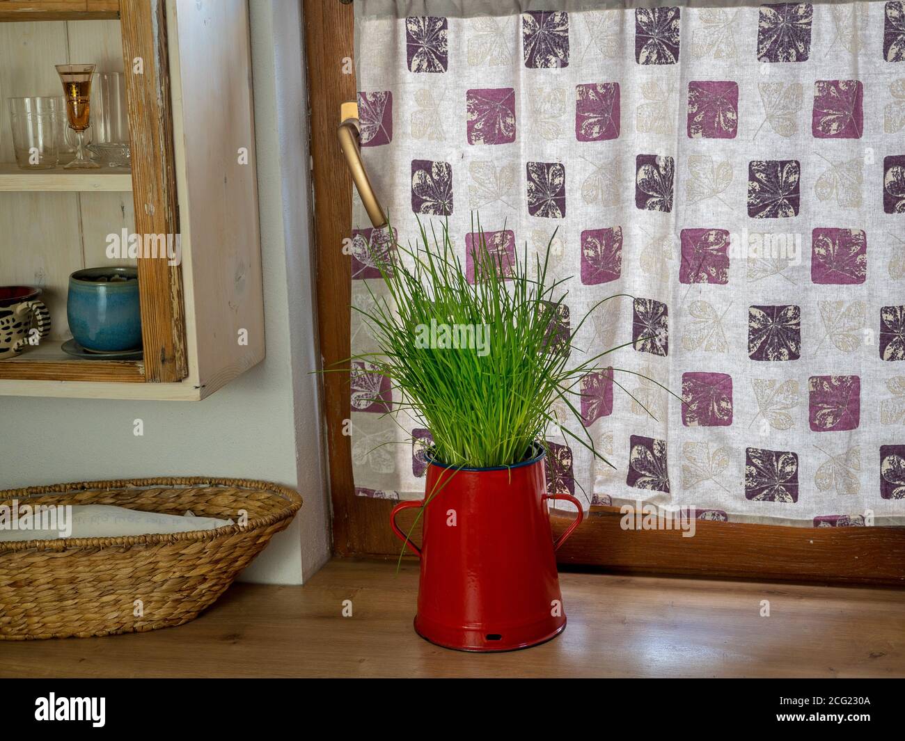 Wooden kitchen in vintage style. Green chives in red metal pot Stock ...