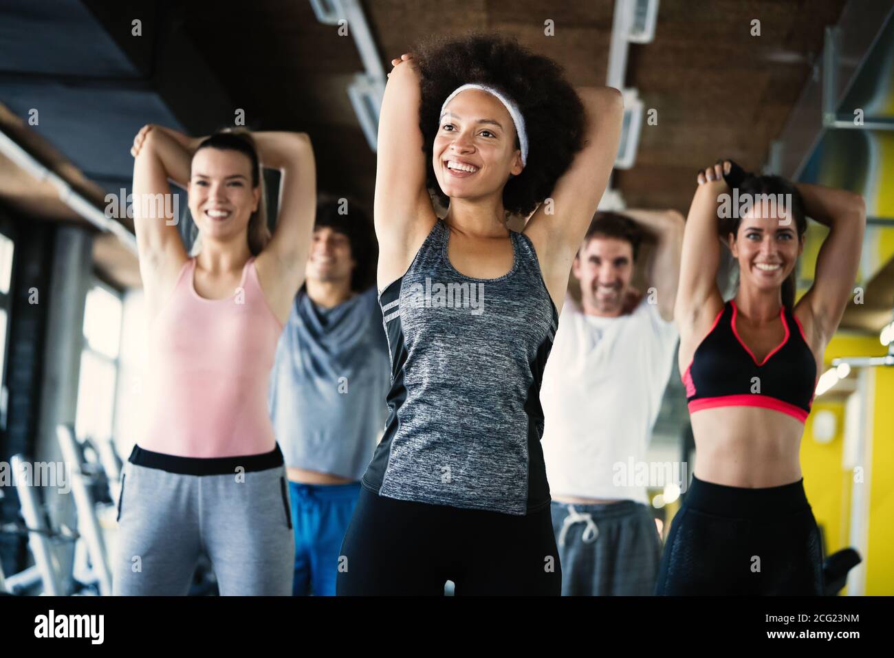 Group of healthy fit people at the gym exercising Stock Photo - Alamy