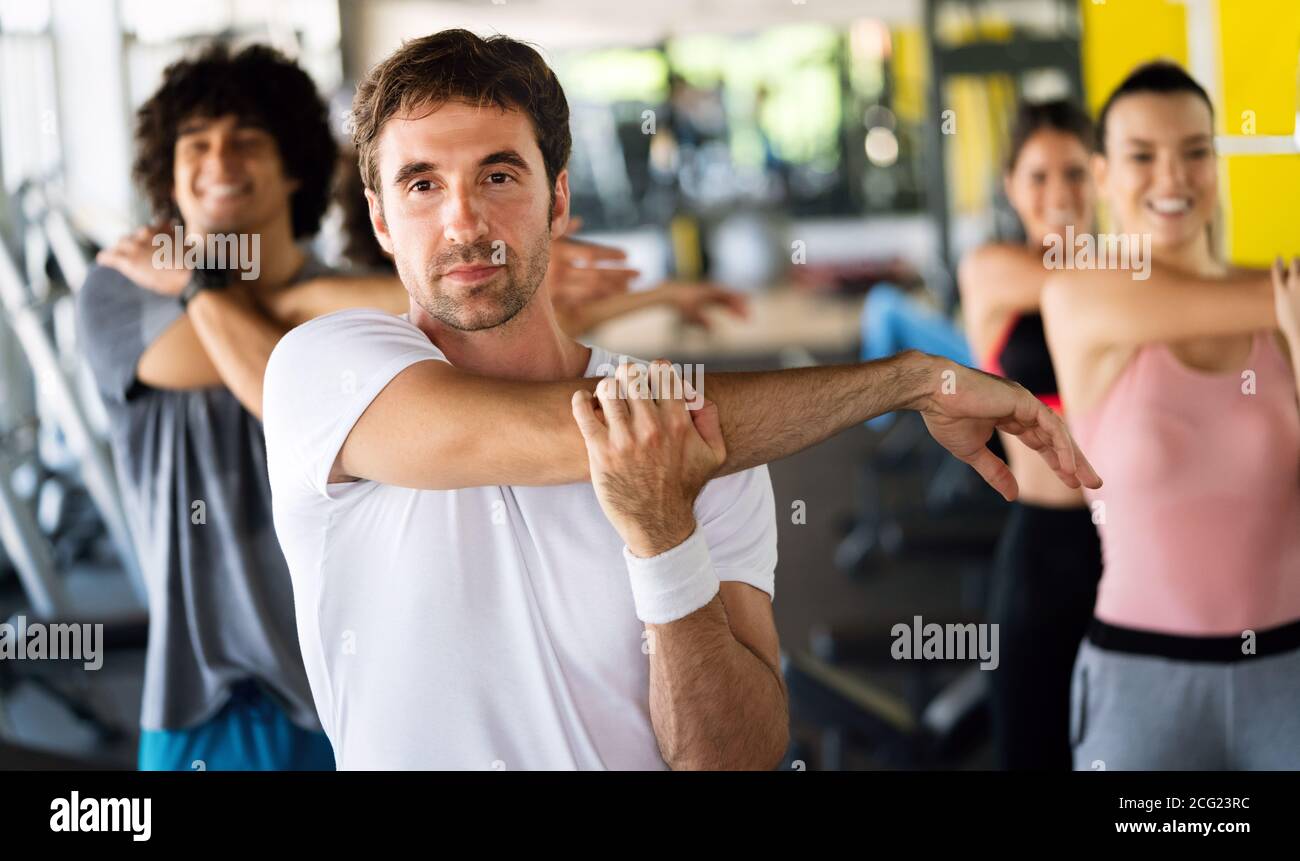 Beautiful fit people exercising together in gym Stock Photo - Alamy