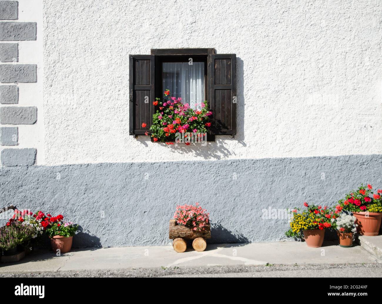 Characteristic window with flower pots in a village in the Italian ...