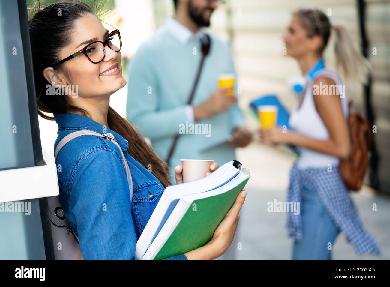 Happy young university students friends studying with books at ...
