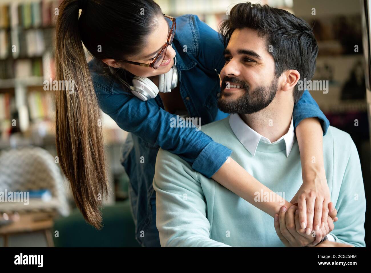 Enjoying student life. Smiling young happy students couple studying and ...