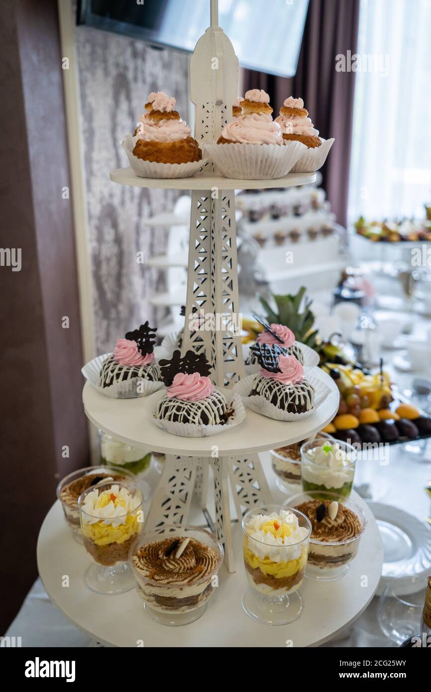Wedding sweets, decorated tables, decorations and cupcakes, delicious ...