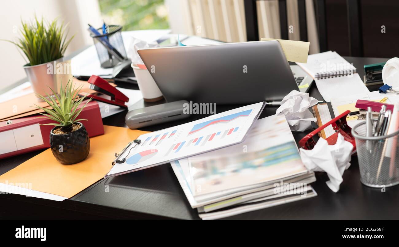 Messy and cluttered office desk Stock Photo - Alamy