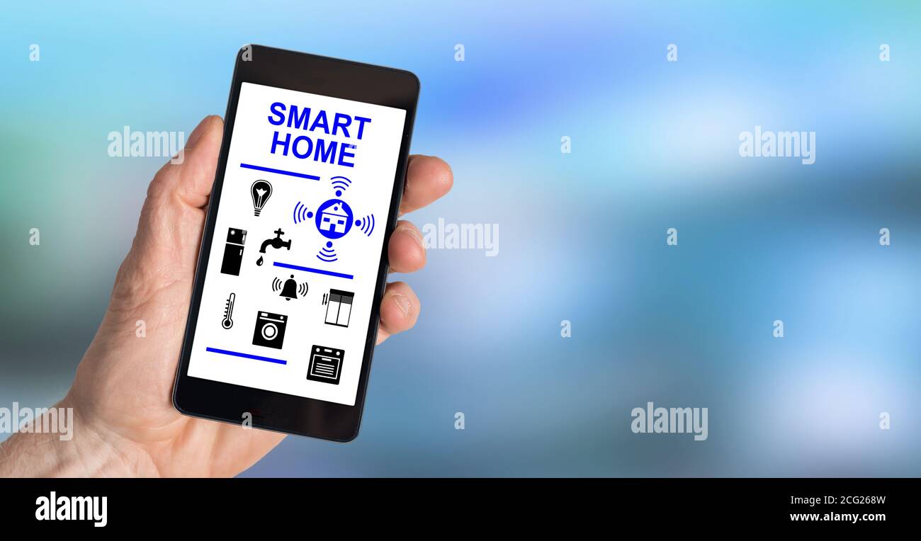 Hand holding a smartphone with smart home concept Stock Photo - Alamy