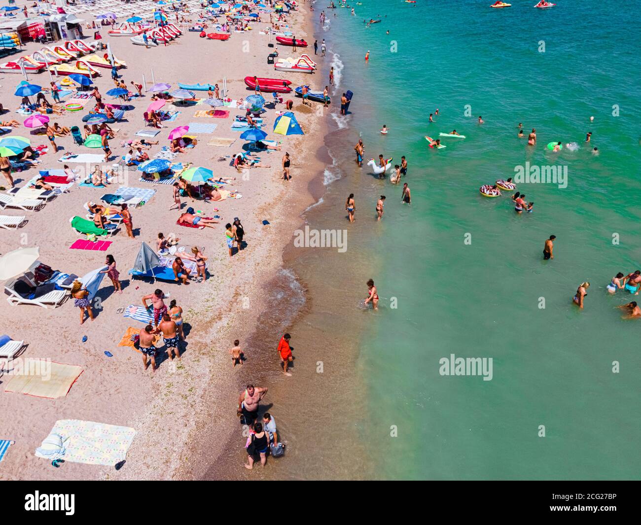 Aerial View Of People And Colorful Umbrellas On Ocean Seaside Beach In ...
