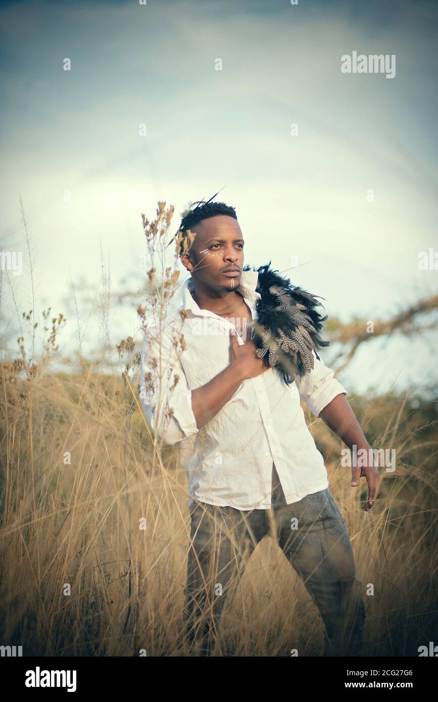 african gentleman in the african bush with bush hat in the grass Stock ...