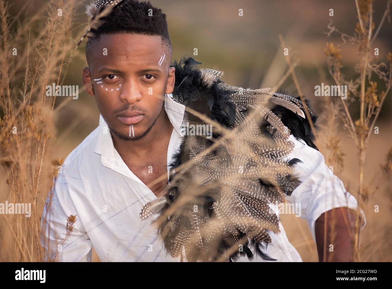 african gentleman in the african bush with bush hat in the grass Stock ...