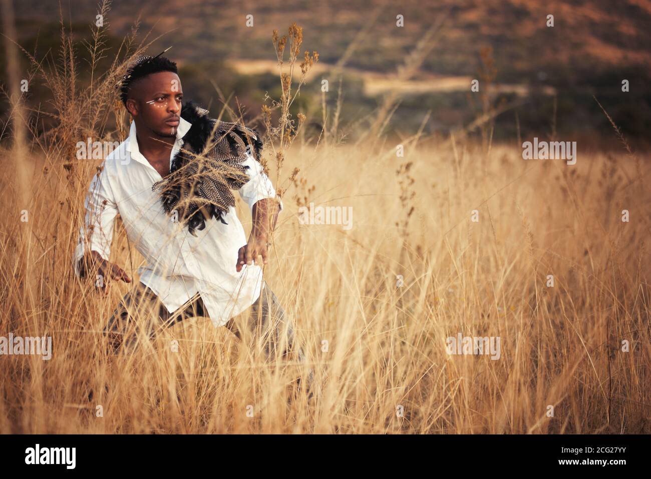 african gentleman in the african bush with bush hat in the grass Stock ...