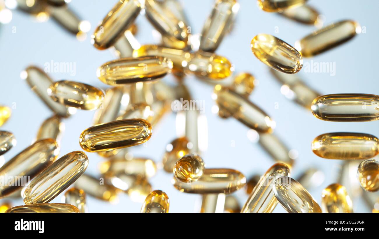Freeze motion of flying group of fish fat pills on white background ...