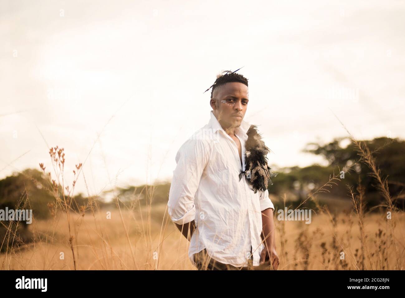african gentleman in the african bush with bush hat in the grass Stock ...