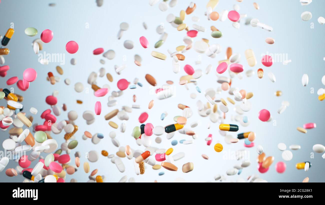 Freeze motion of flying pills on white background. Health and medical ...