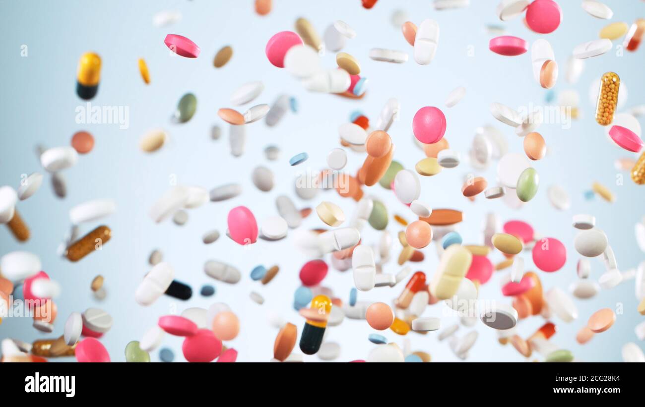 Freeze motion of flying pills on white background. Health and medical ...