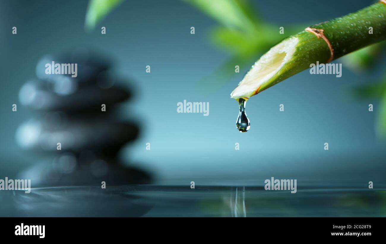 Dripping drops from bamboo tube, spa and wellness concept Stock Photo ...