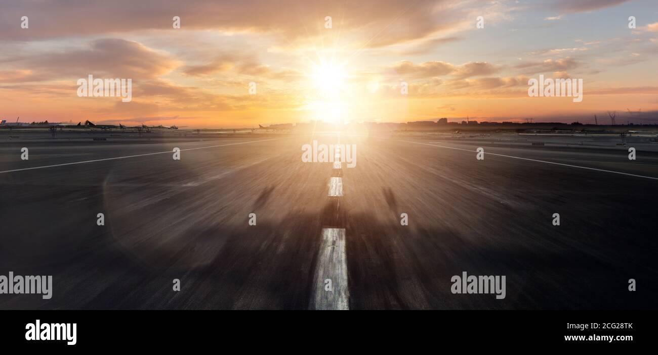Empty airplane runway with dramatic sunset light. Travel and ...