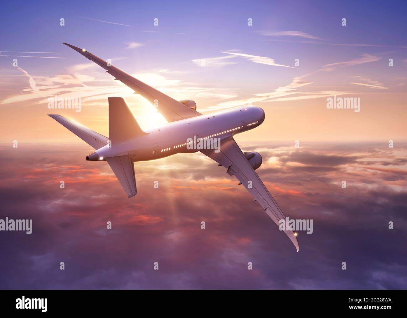 Passengers commercial airplane flying above clouds in sunset light ...