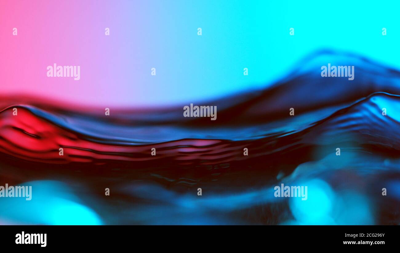 Detail of water waves highlighted by neon lights. Abstract water ...