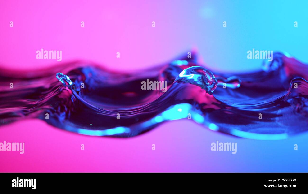 Detail of water waves highlighted by neon lights. Abstract water ...