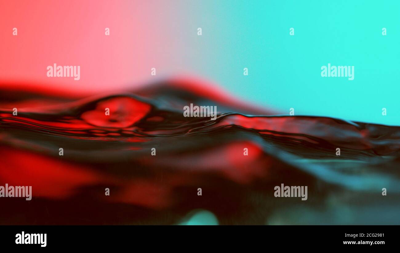 Detail of water waves highlighted by neon lights. Abstract water ...