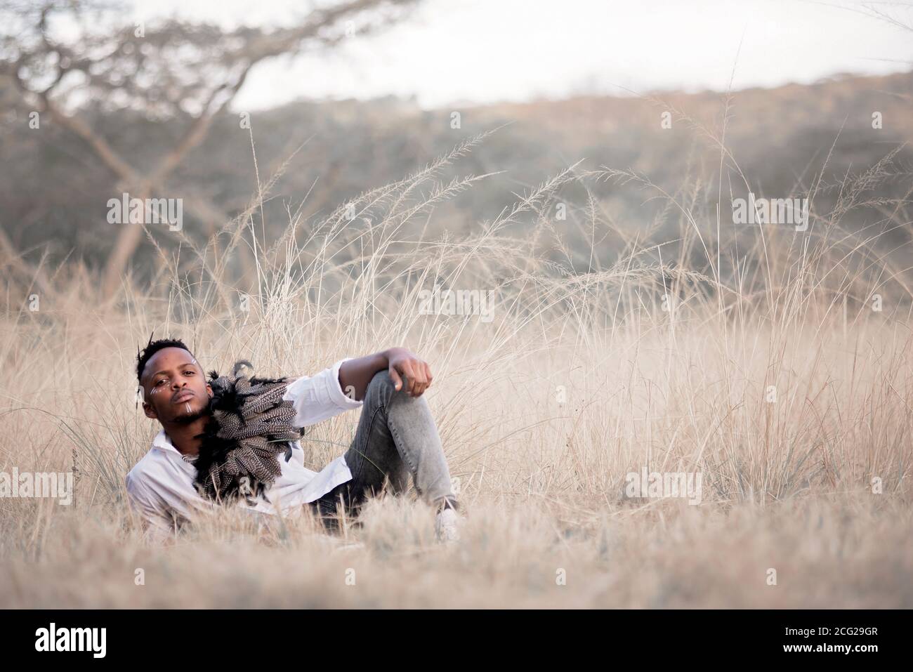 african gentleman in the african bush with bush hat in the grass Stock ...
