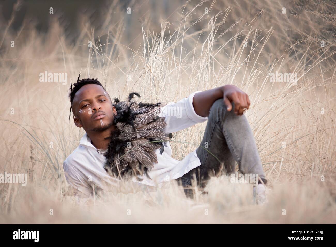 african gentleman in the african bush with bush hat in the grass Stock ...
