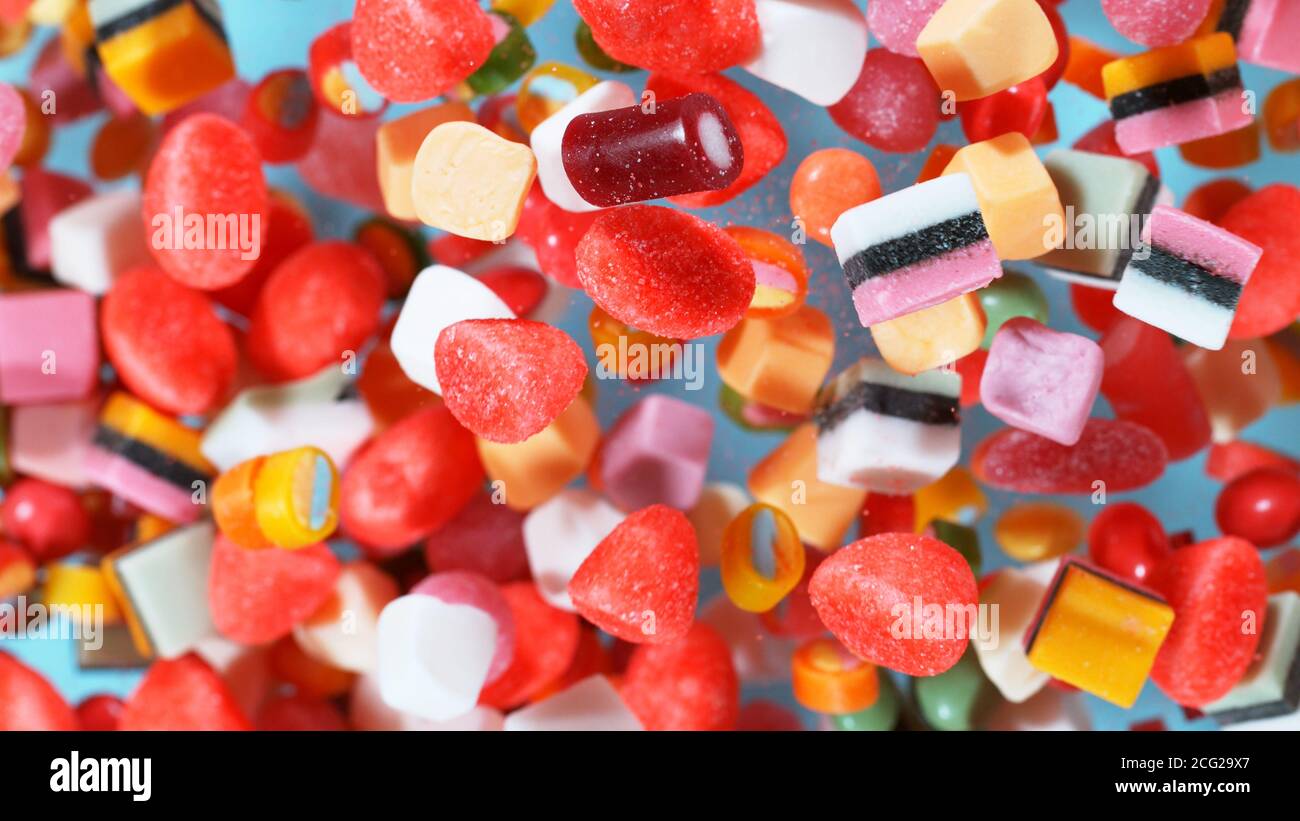 Flying sweet candies up in the air in freeze motion Stock Photo - Alamy