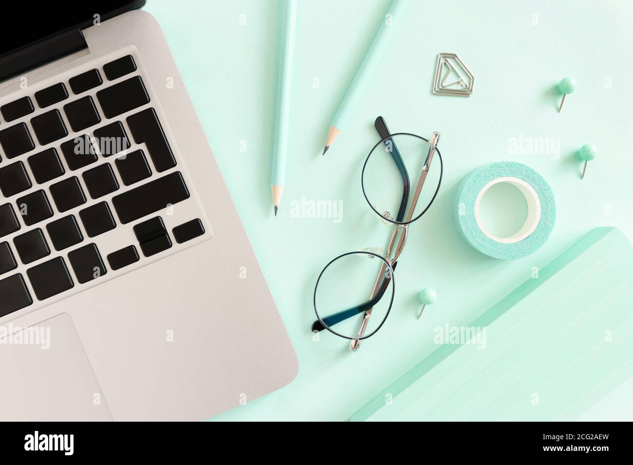 Composition with laptop, glasses and stationery on the mint table Stock ...