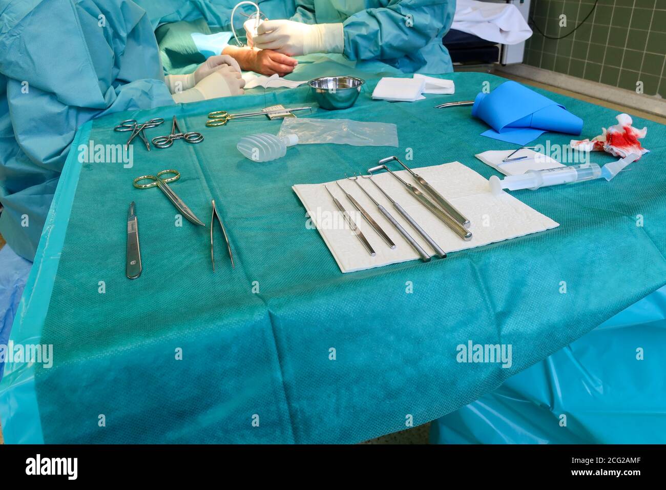 a plastic surgeon performs hand surgery on a patient in an operating ...
