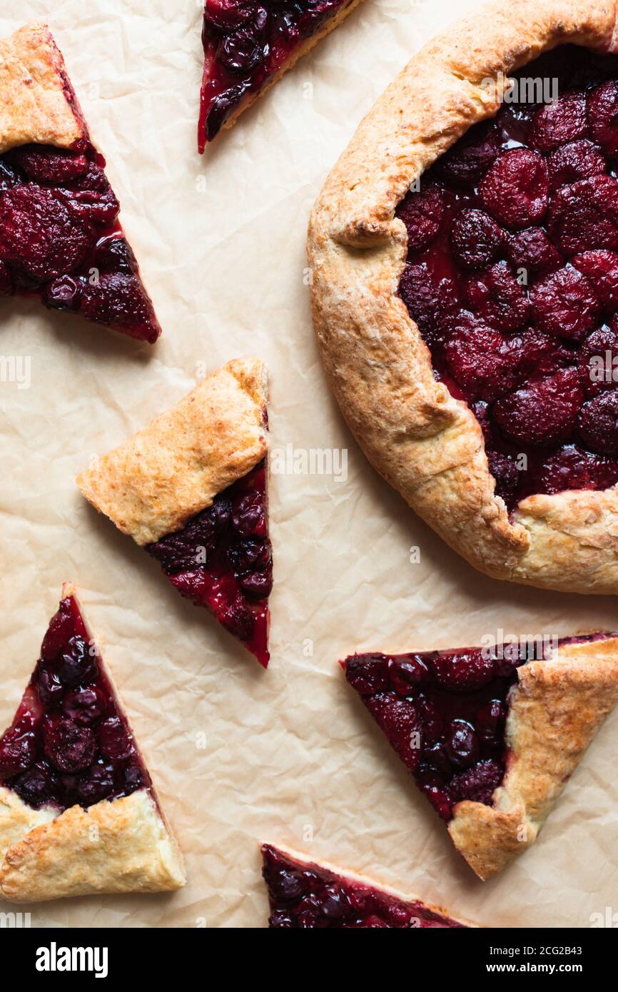 Pieces of homemade berry cake on a kraft baking paper Stock Photo - Alamy