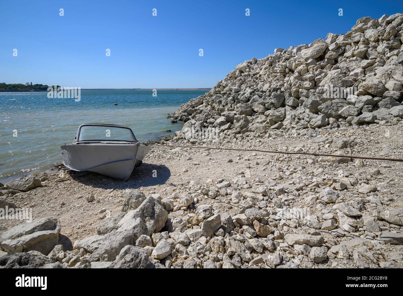 Empty old metal fishing motor boat at shore Stock Photo - Alamy