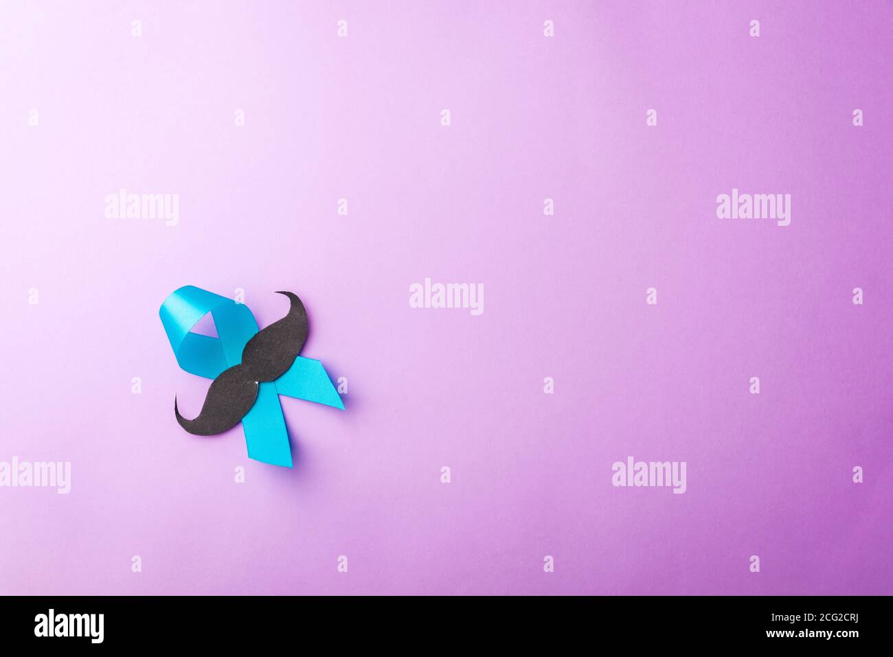 Black mustache paper and light blue ribbon, studio shot isolated on ...