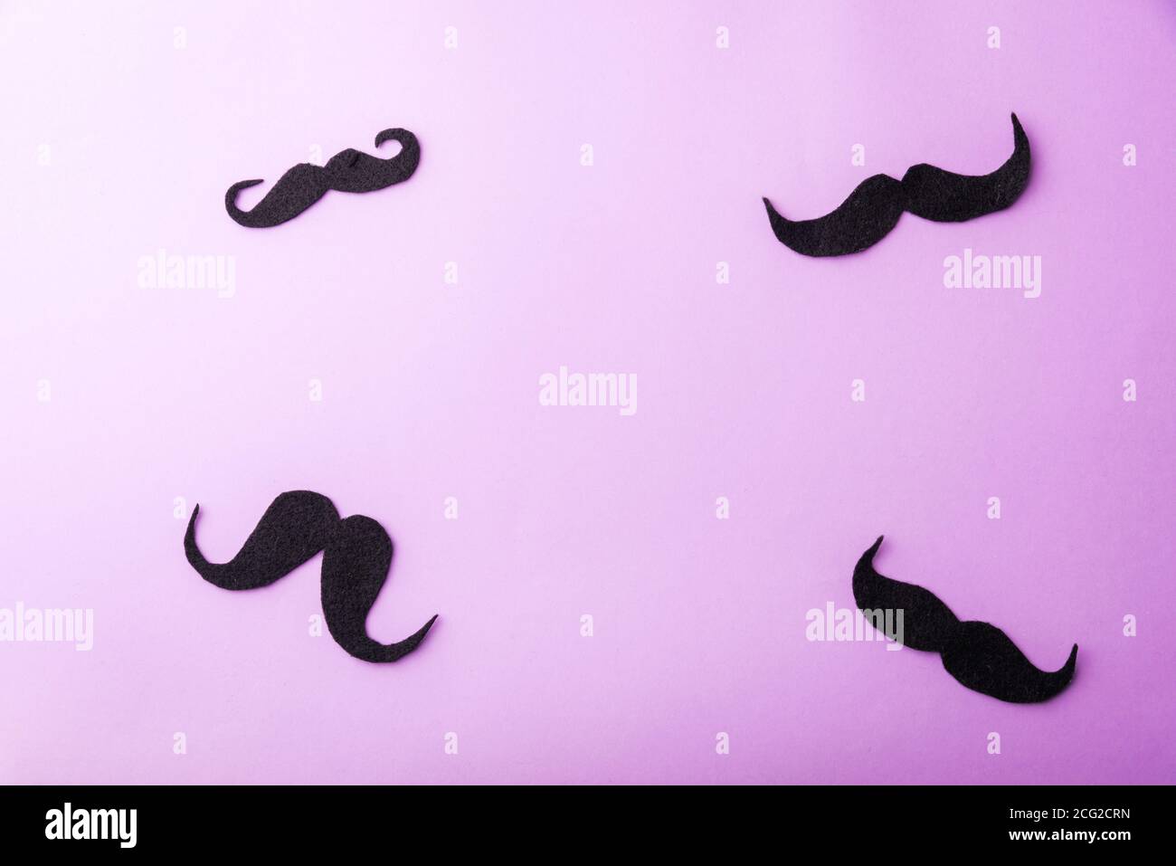 Black mustache paper, studio shot isolated on purple background ...