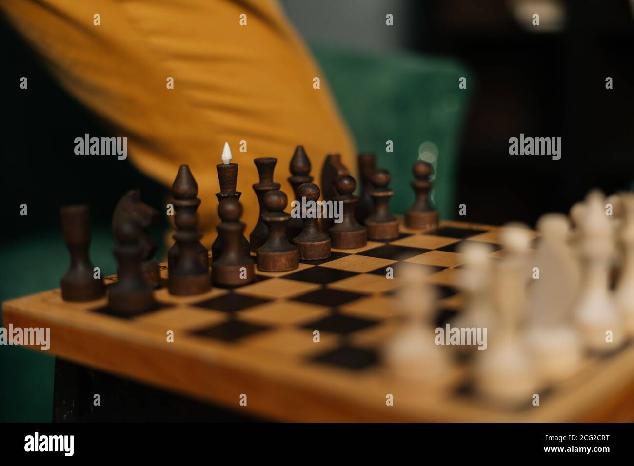 Side view of chessboard with placed chess pieces on black old vintage ...