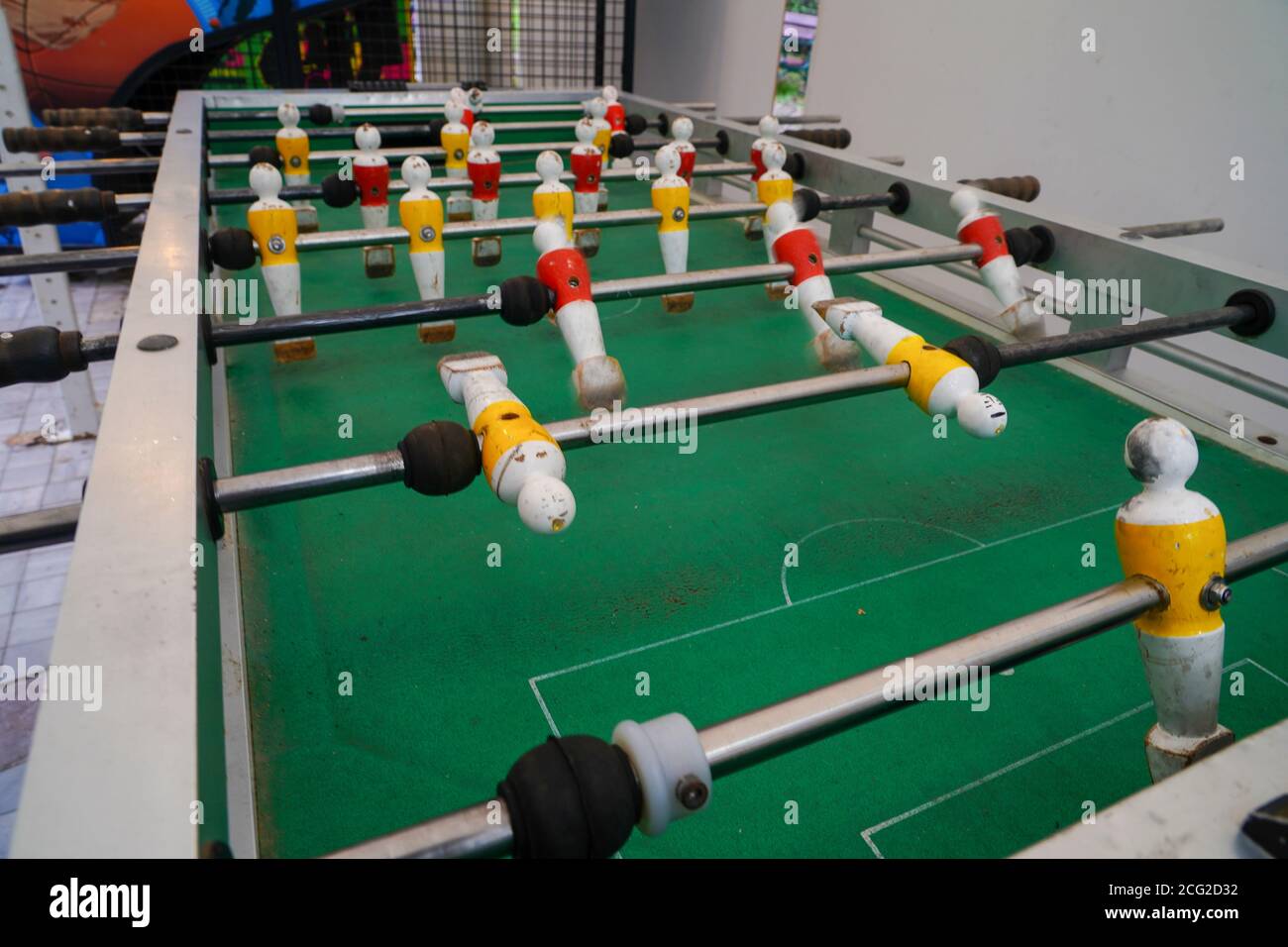Yellow and red players on a foosball table Stock Photo - Alamy