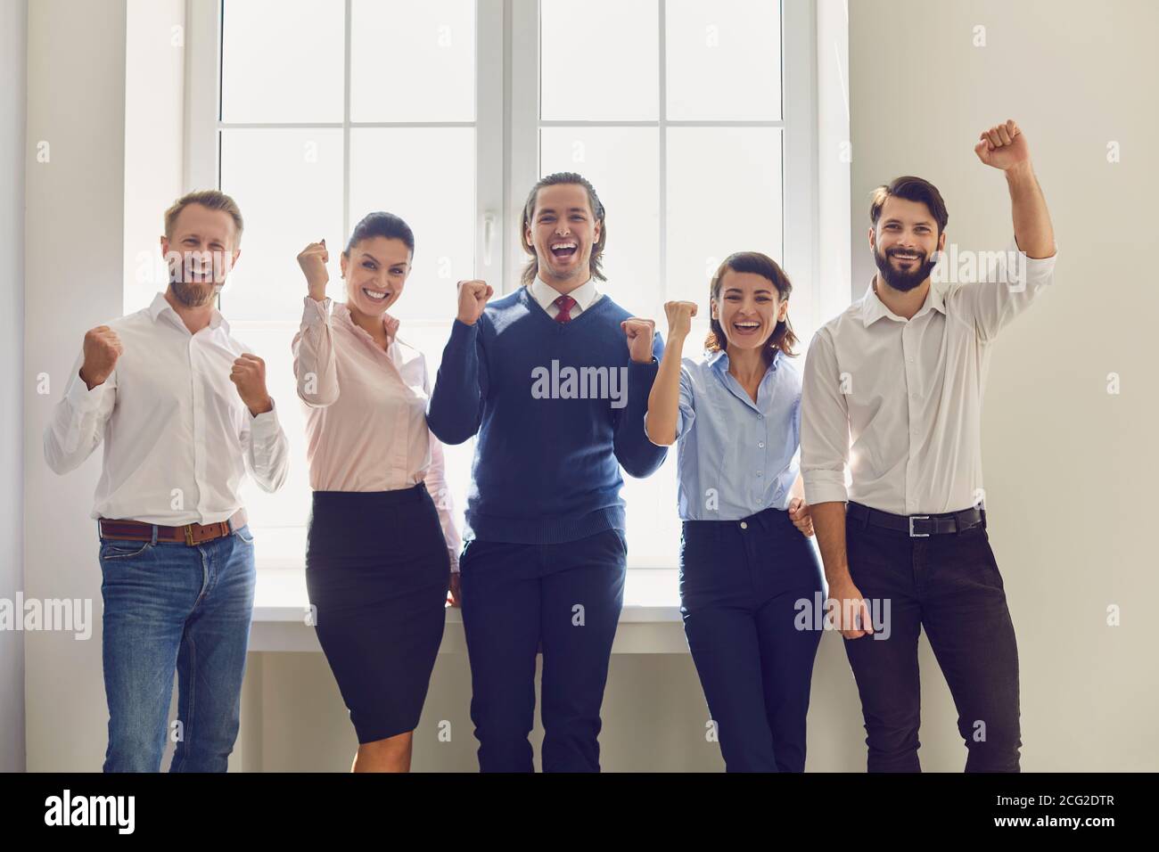 Group of smiling business people expressing successful teamwork or ...