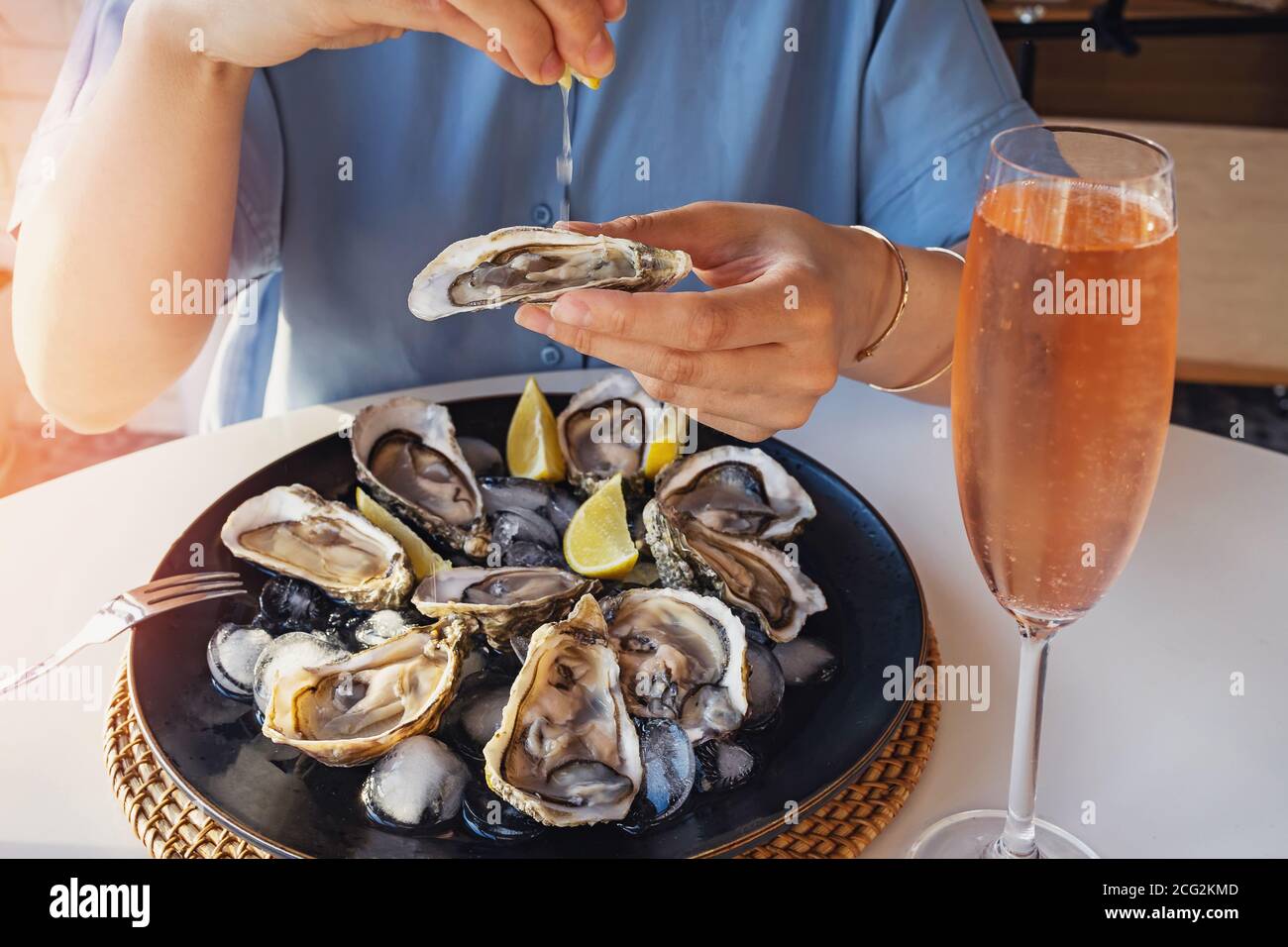 Woman eating oysters hi-res stock photography and images - Alamy